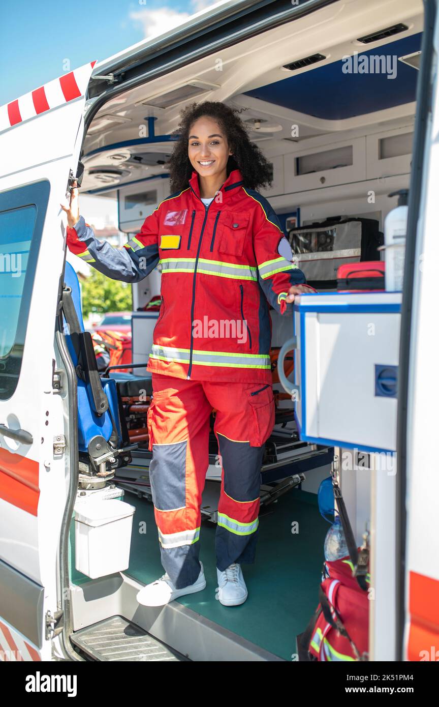 Joyous paramedic posing for the camera in the ambulance car Stock Photo ...