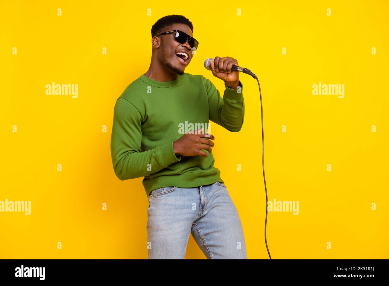 Portrait of attractive trendy cheerful guy rest free time singing ...