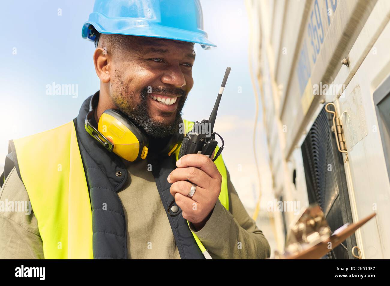Logistics, communication and black man talking on walkie talkie working ...