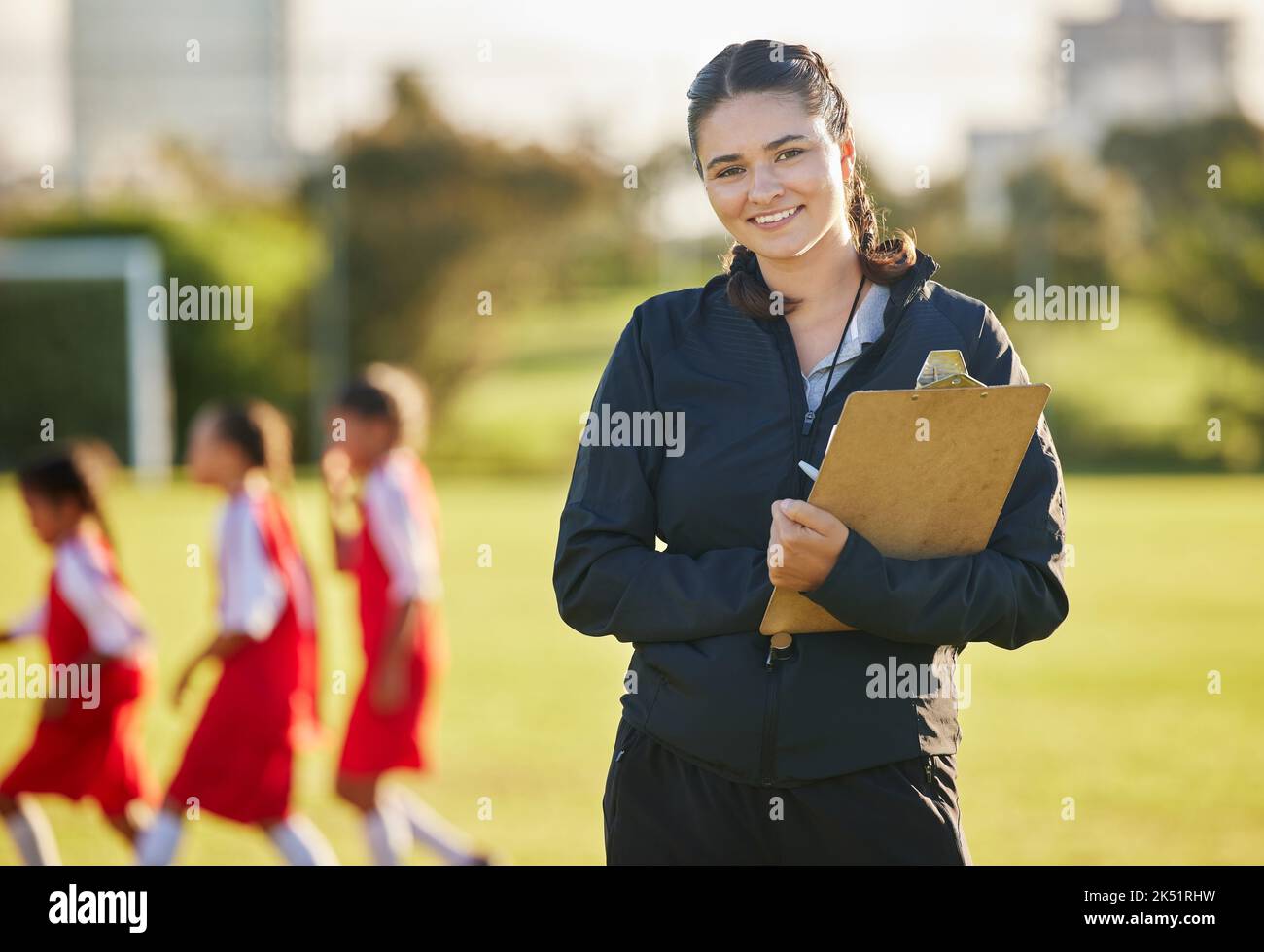 Soccer field, woman coach with and girl team training on grass in ...