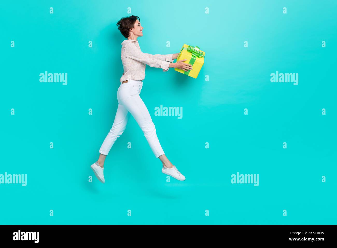 Full length profile side photo of positive lady carry give present ...