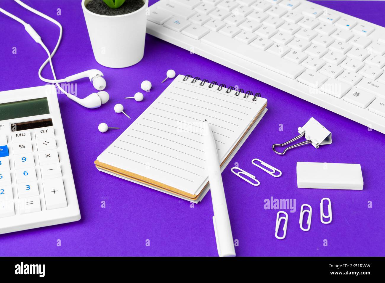 Composition of office lifestyle items on purple background, computer ...