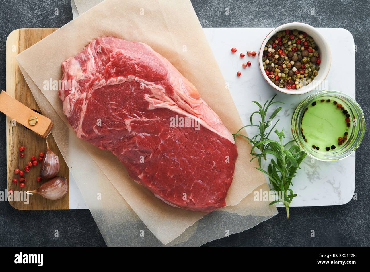 Steaks. Fresh New York Steaks raw with spices rosemary and pepper on ...