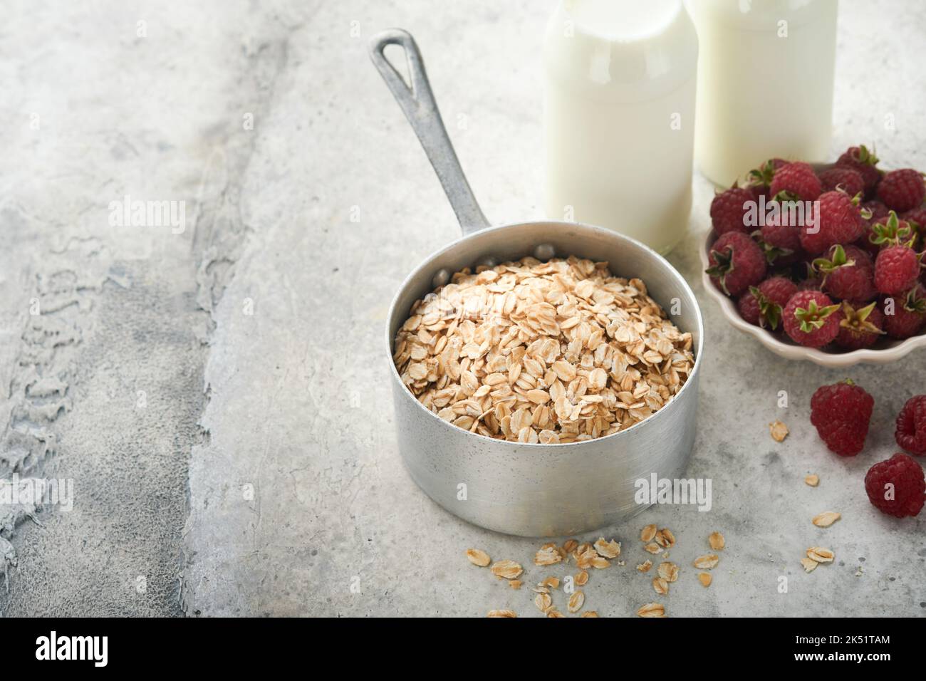 Ingredients for cooking oatmeal or granola with oats, milk, raspberries ...