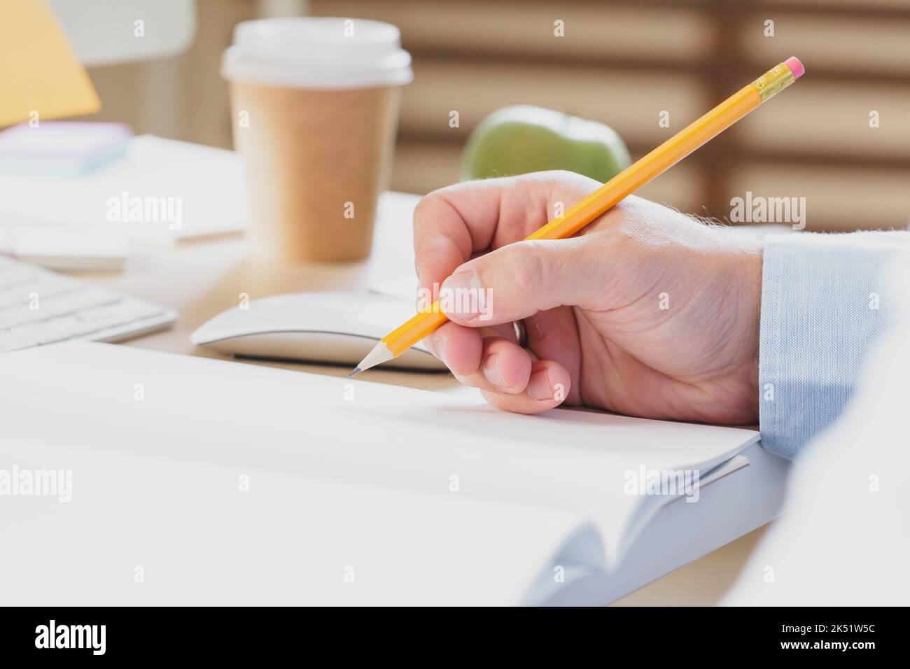 Businessman hands with pen writing notebook on office desk table ...