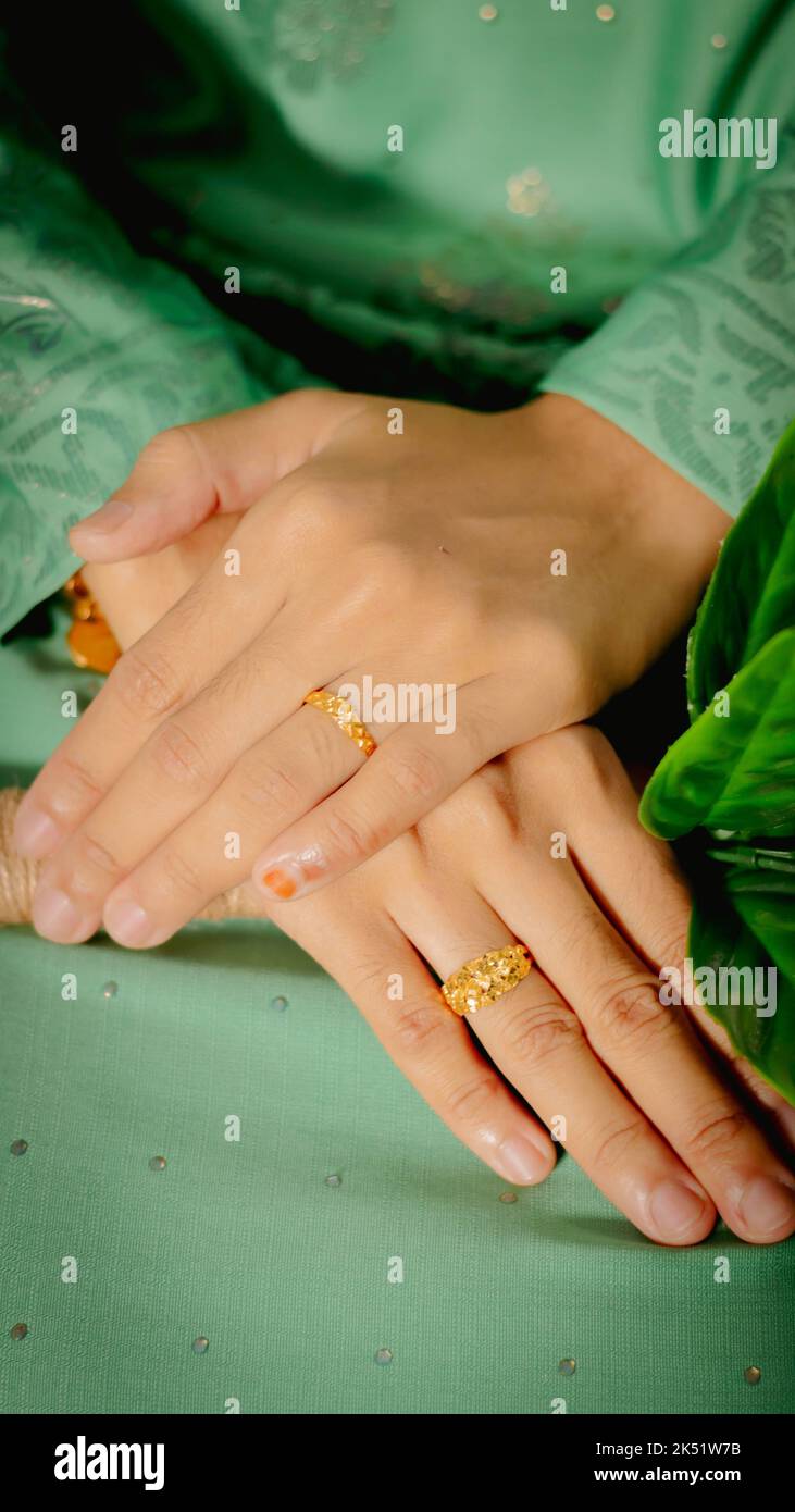 Beautiful golden rings on girl's hands Stock Photo - Alamy