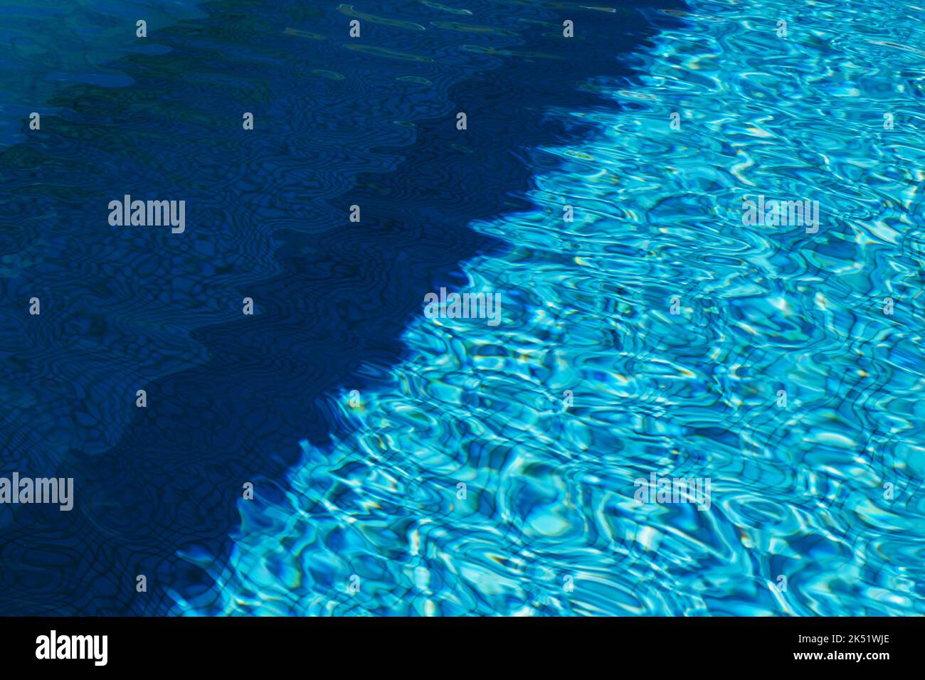 Two colored light and dark blue water with ripples and sunny ...