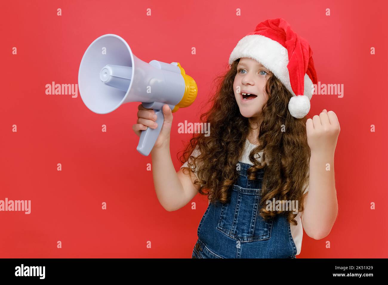 Promoter little girl child wears white t-shirt and Santa hat scream in ...