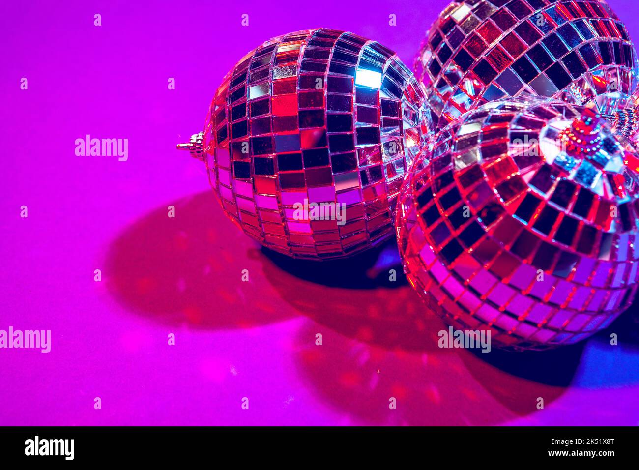 Shiny small disco balls sparkling in a beautiful purple light. Disco ...