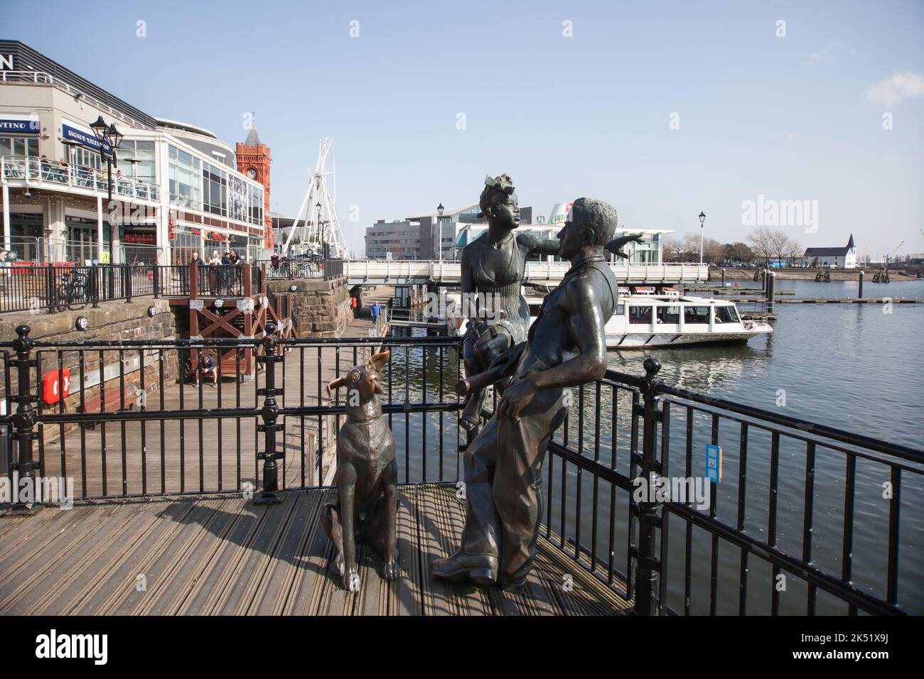 A statue of a man a woman and a dog at Cardiff Bay in Cardiff in the UK ...