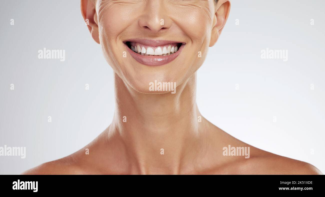 Teeth, face and mature woman beauty showing her natural looking dental ...