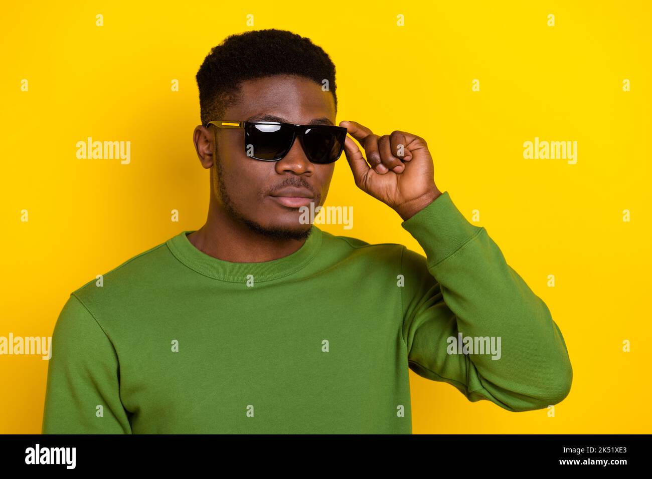 Portrait of attractive content guy dandy touching specs good look ...