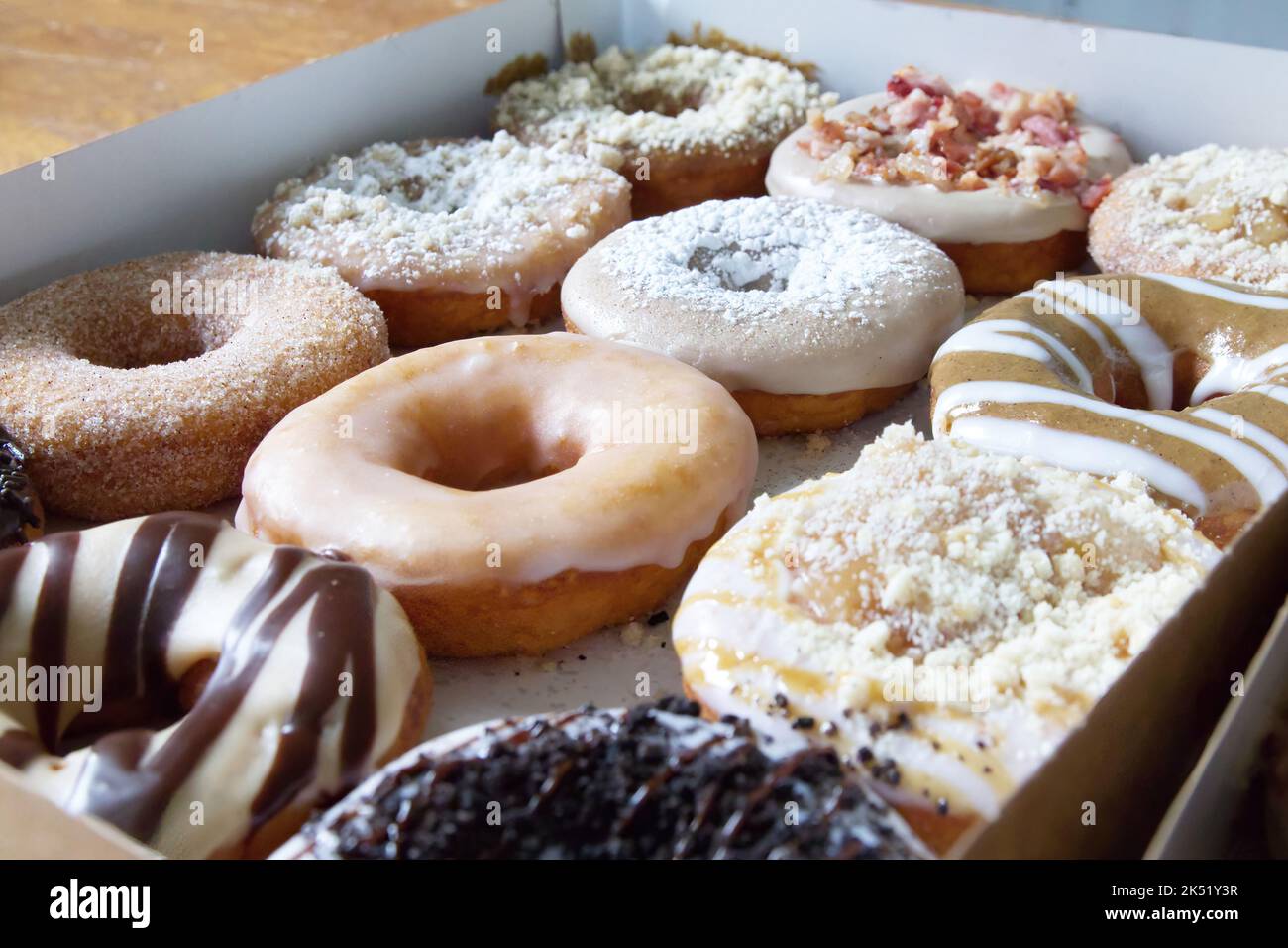 Picture of assorted donuts in a box with chocolate frosted, glazed, and ...