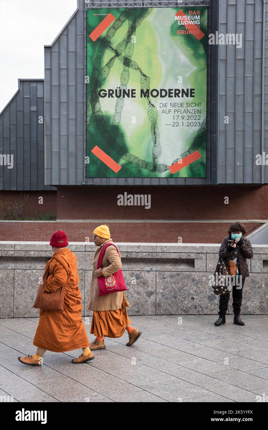 buddhist monks pass a poster at Museum Ludwig, Cologne, Germany ...