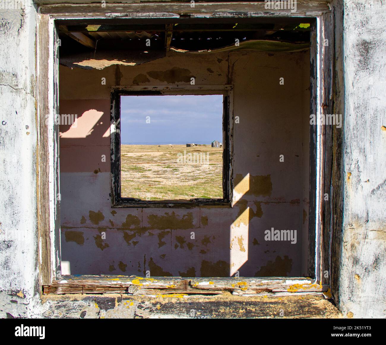 View through a window in a derelict hut to the foreshore Stock Photo ...