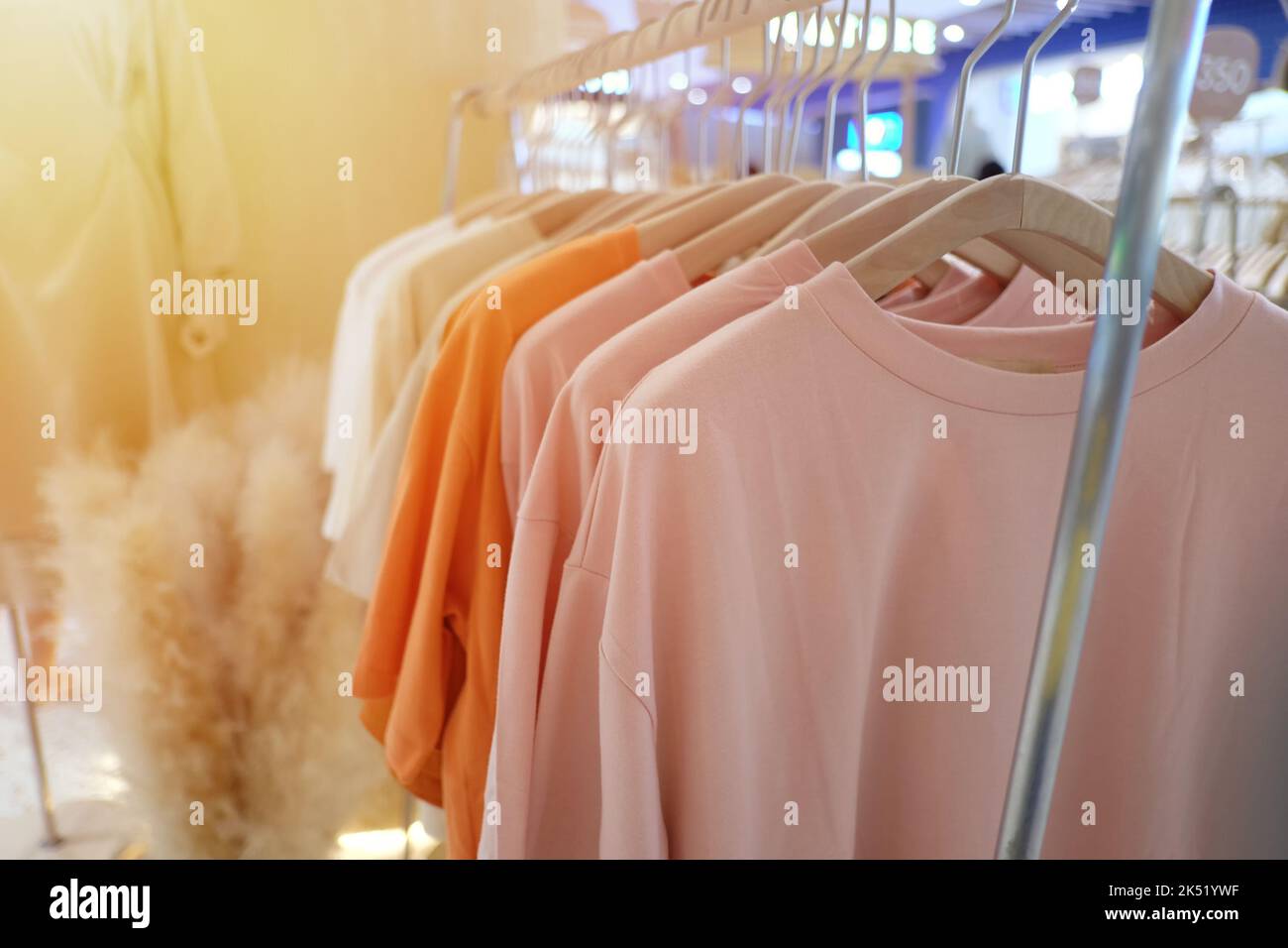 Colorful clothes hanging on clothesline and have orange sunlight shines ...