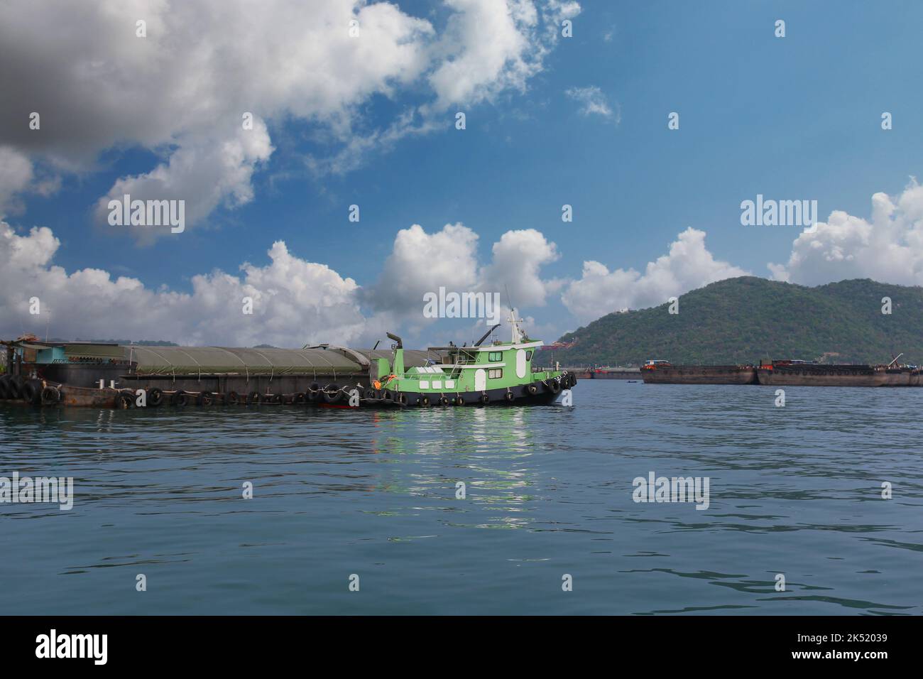 Tug boats and cargo ships moored in the bay of Koh Sichang ...
