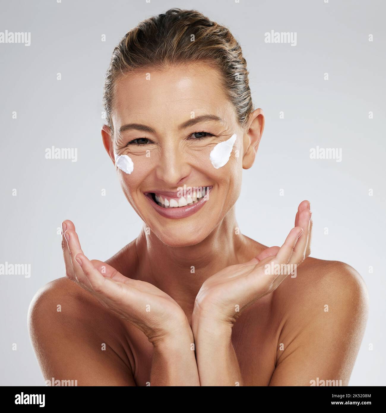 Skincare, elderly woman and cosmetics cream in grey studio background ...