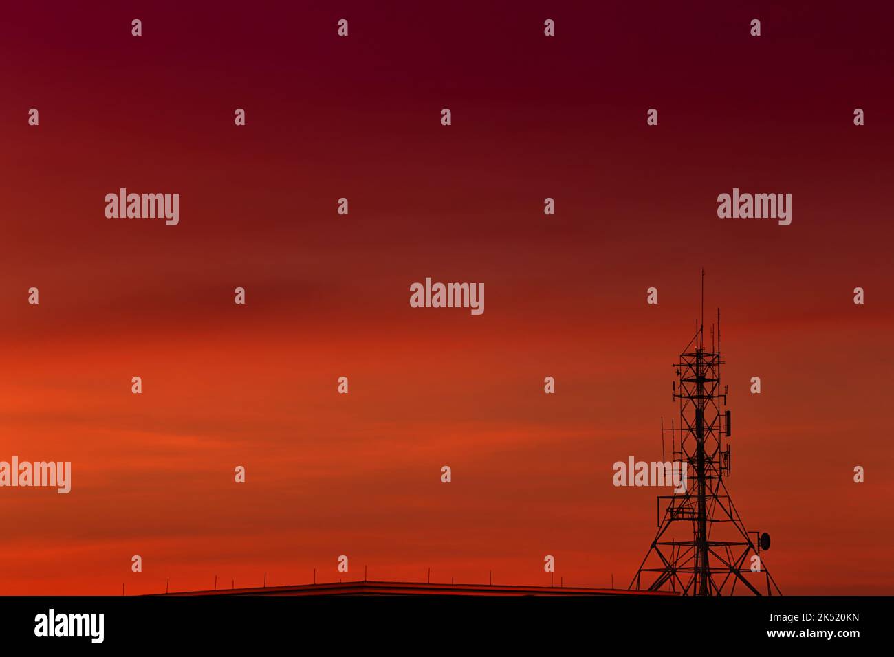 Red and orange sky background with telephone tower silhouette for ...