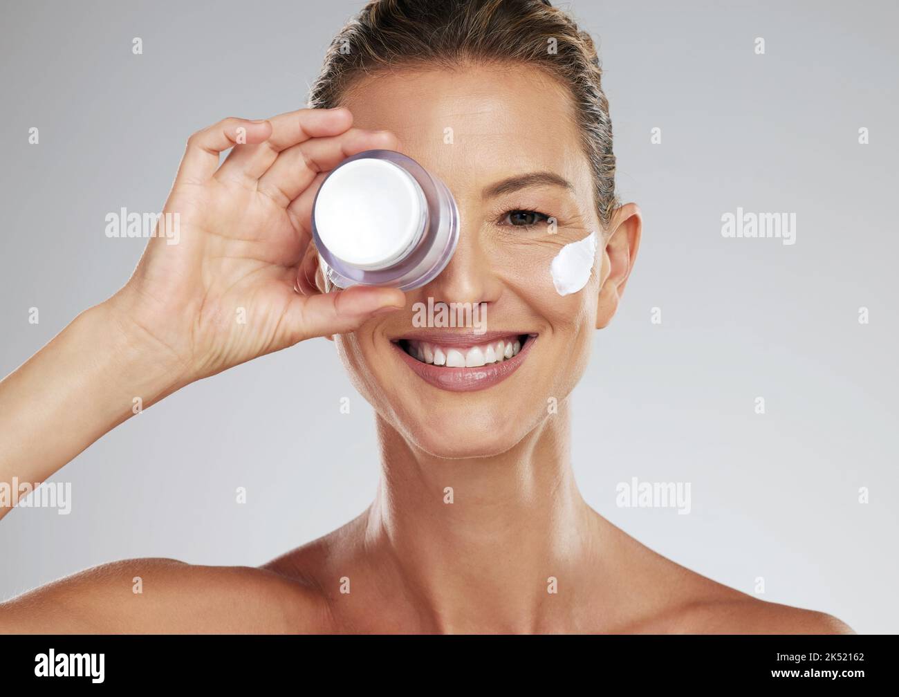 Face cream, skincare and portrait of a mature woman in a studio ...