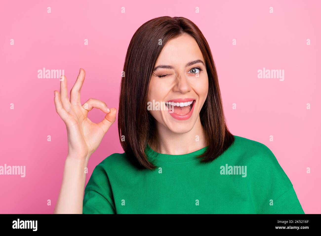 Closeup photo of young attractive woman showing okey sign blink flirty ...