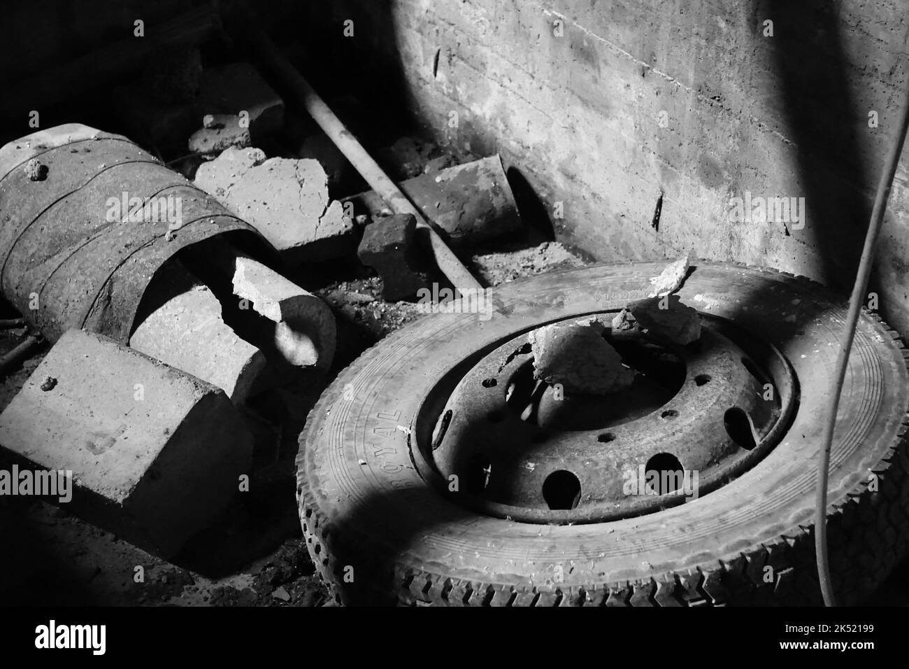A grayscale shot of a dirty and old tire and broken concrete Stock ...