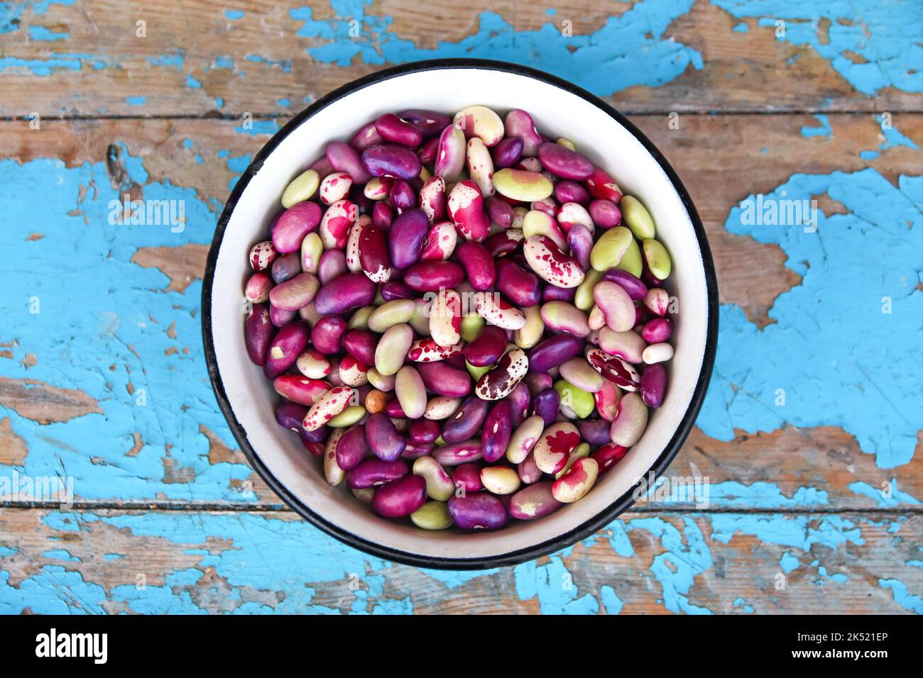 Defocus purple beans background. Plate on blue background of many ...