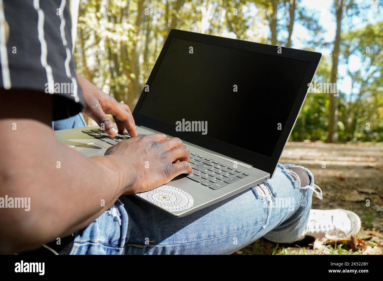 African digital nomad. Black male remote working with a laptop Stock ...