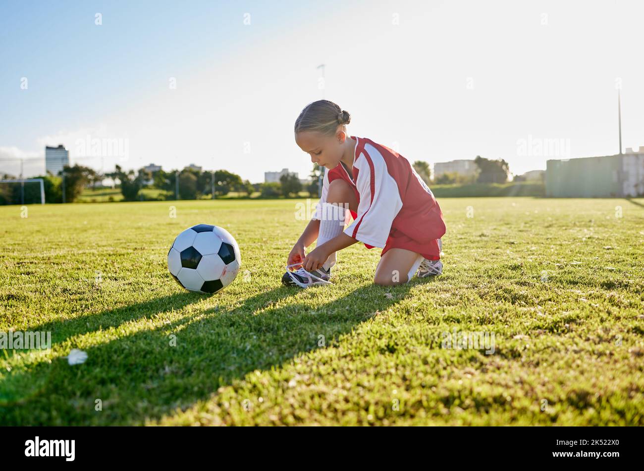 Soccer, training and tie shoes with girl in sports workout for ...