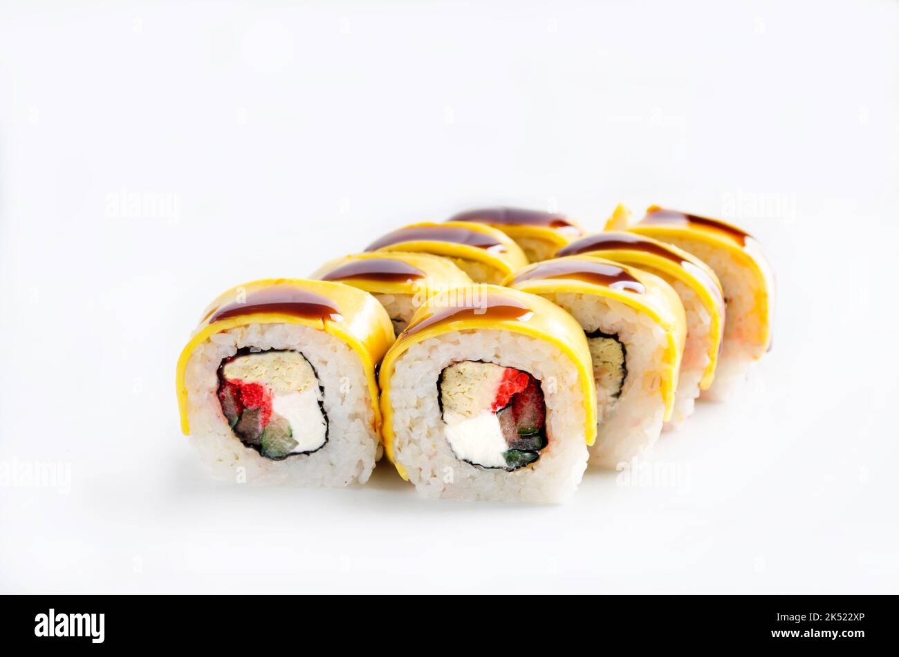 set sushi rolls in cheddar cheese with salmon, cream cheese cucumber ...