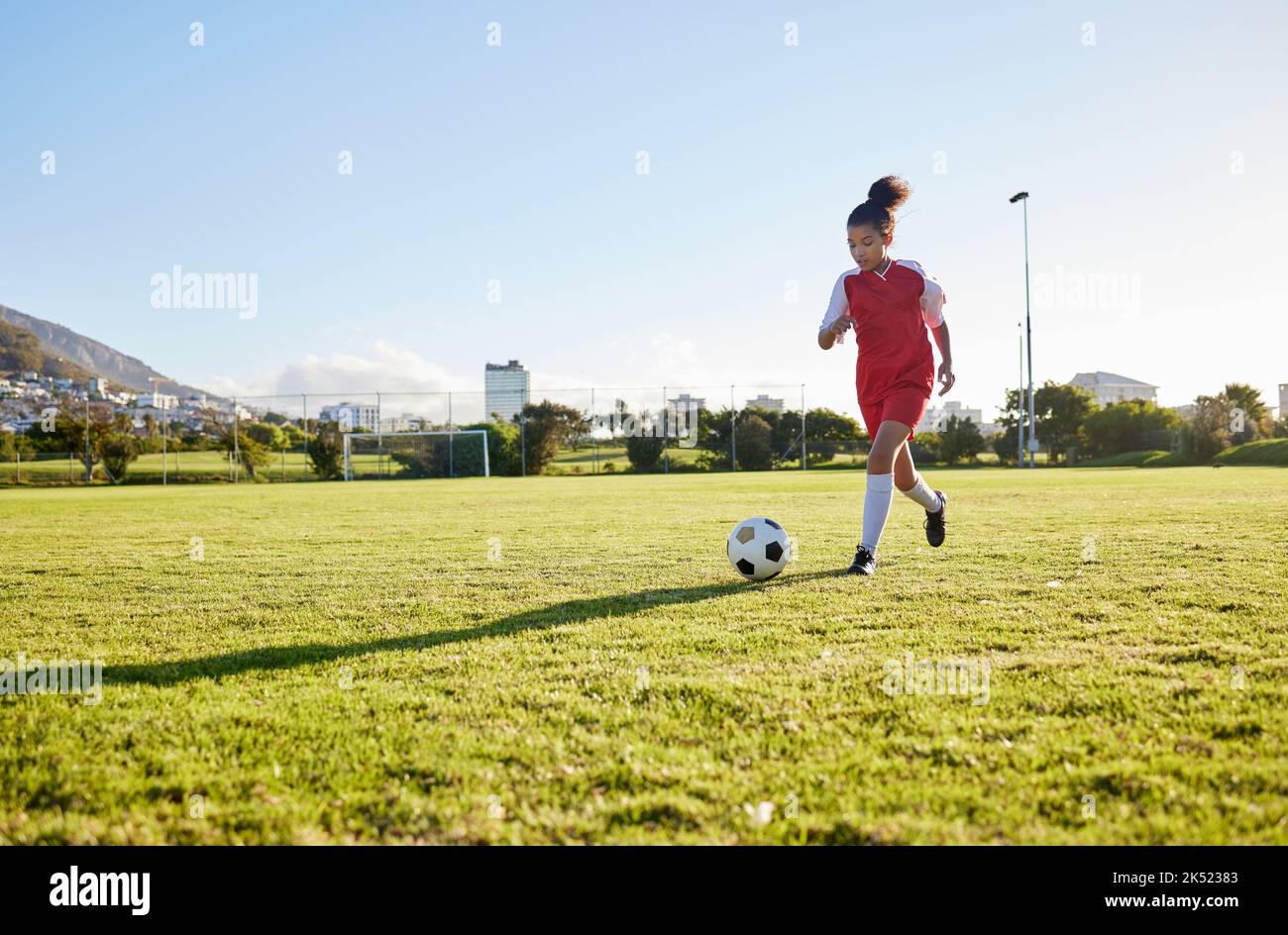 Girl running on grass field, soccer fitness to kick football and young ...