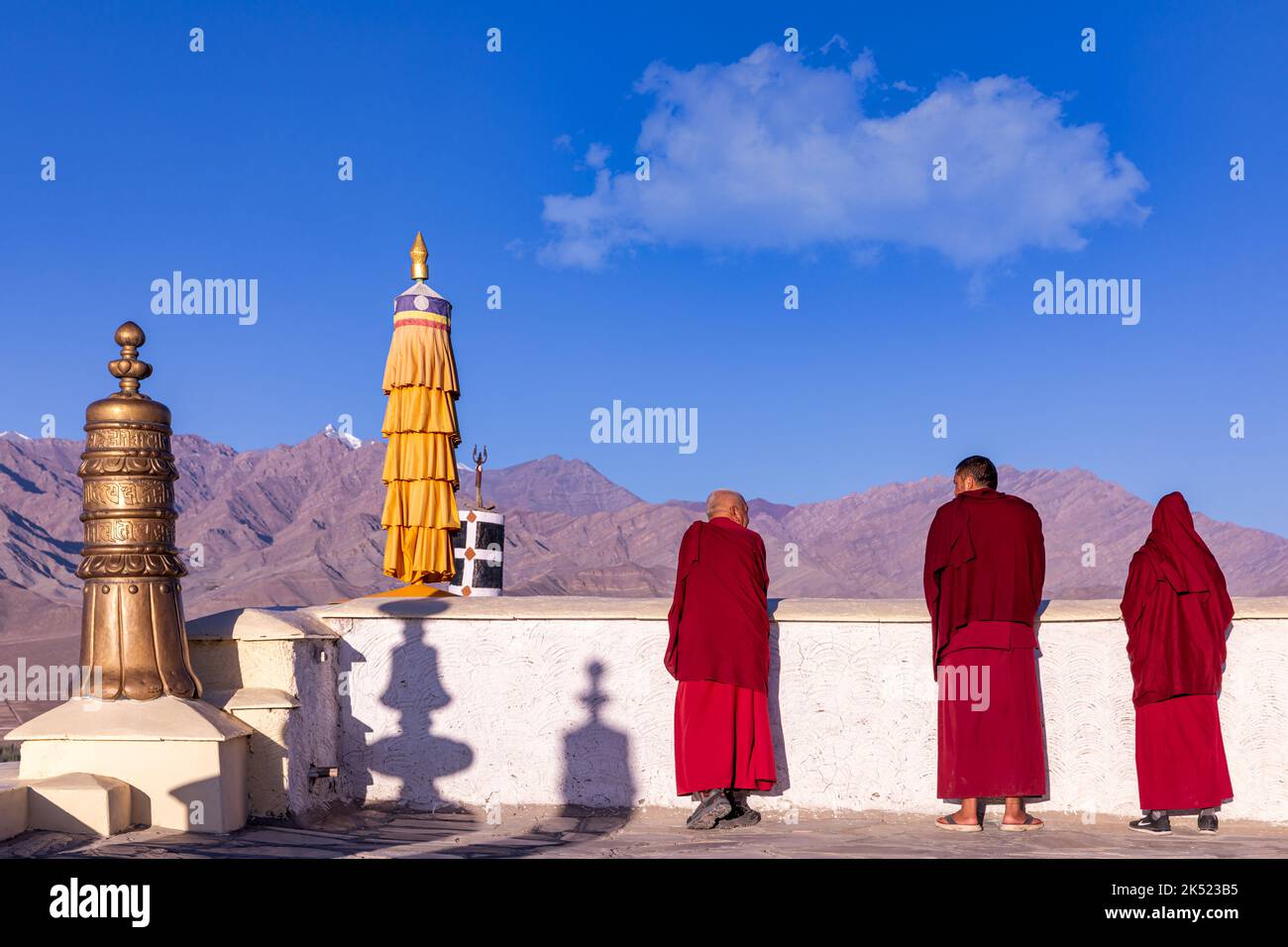 Three monks on the roof at Thikse Monastery (Gompa), Ladakh, India ...