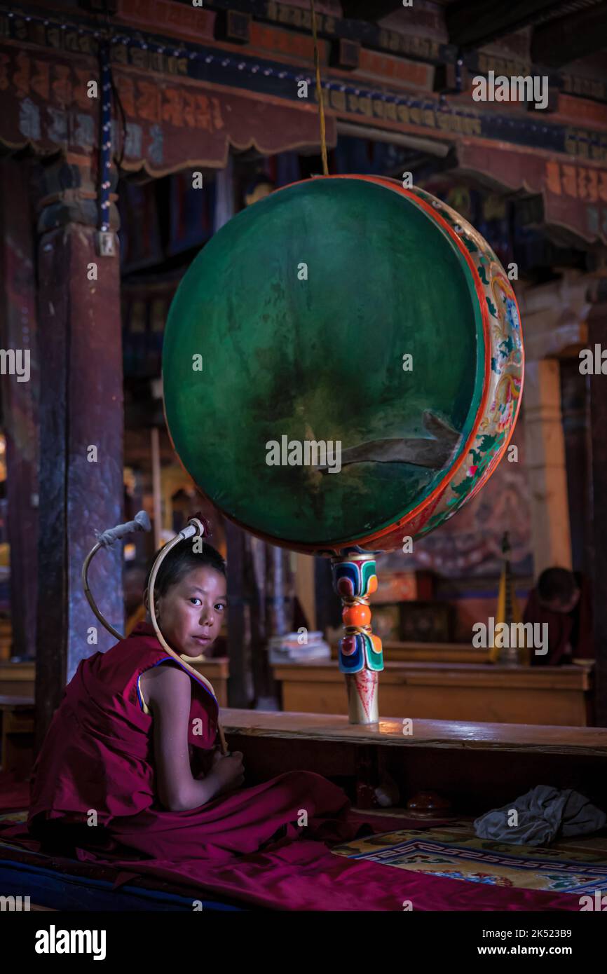 A young monk with a drum at Thikse Monastery (Thiksay Gompa), Ladakh ...