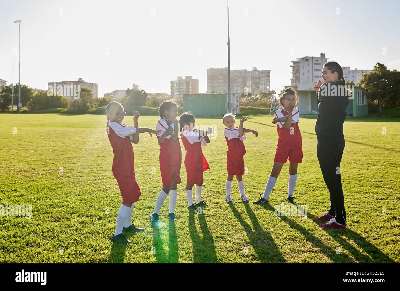 Football girl team stretching with coach on a sports field for fitness ...