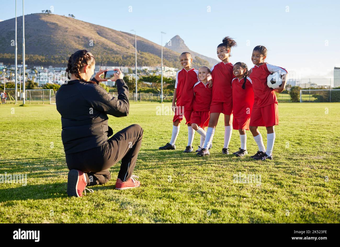 Soccer, phone and team picture with coach, ball and sports girl group ...