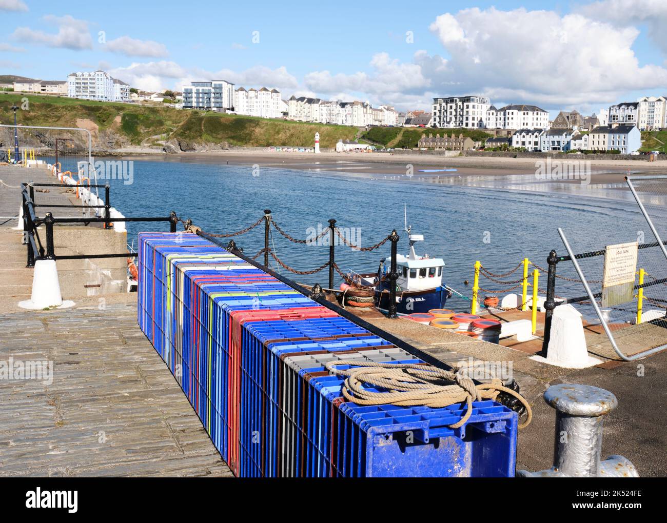 Looking over Port Erin bay, Isle of Man. Colorful plastic crates are ...