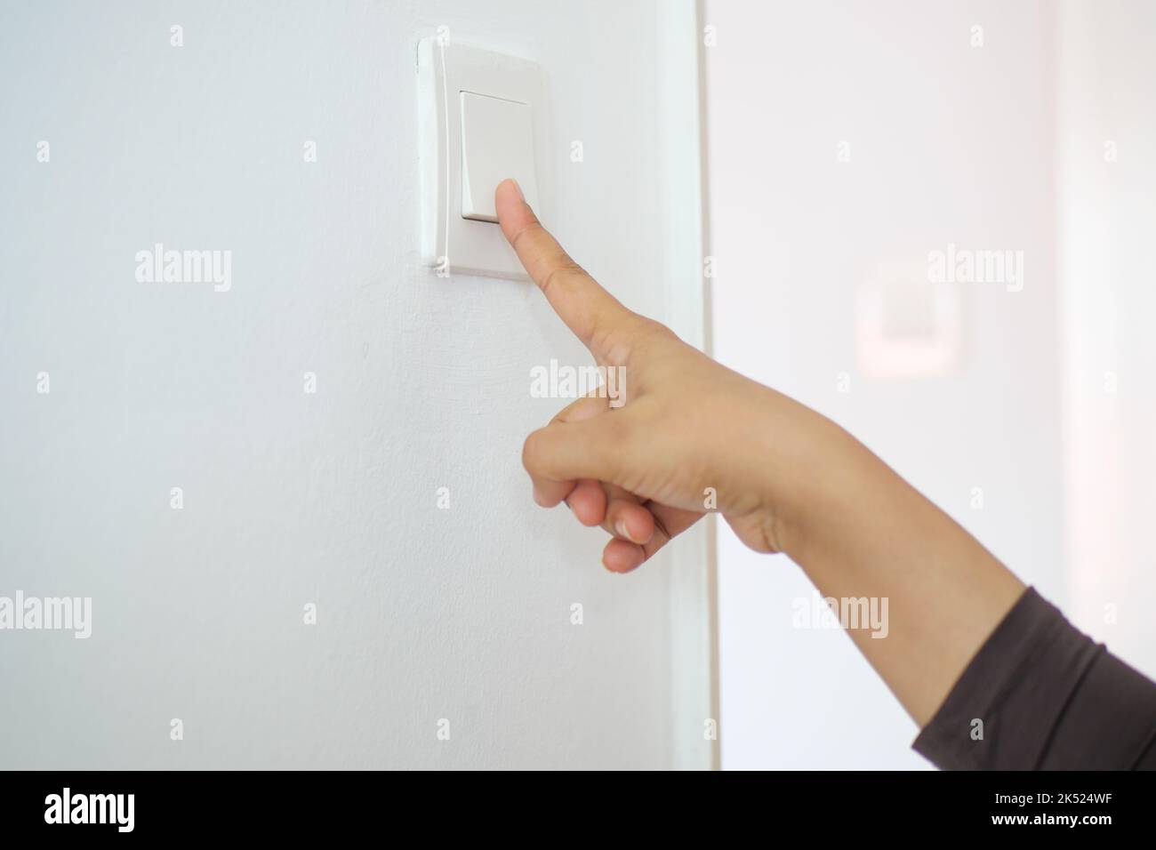 A finger turning on lighting switch Stock Photo - Alamy
