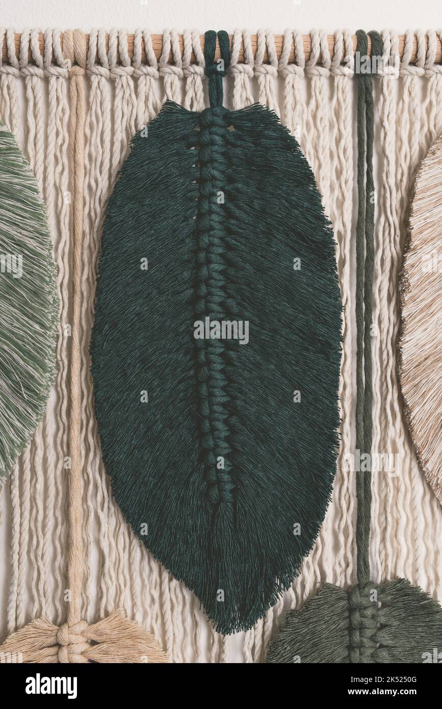 macrame forest green feather cotton string on wall feather closeup ...