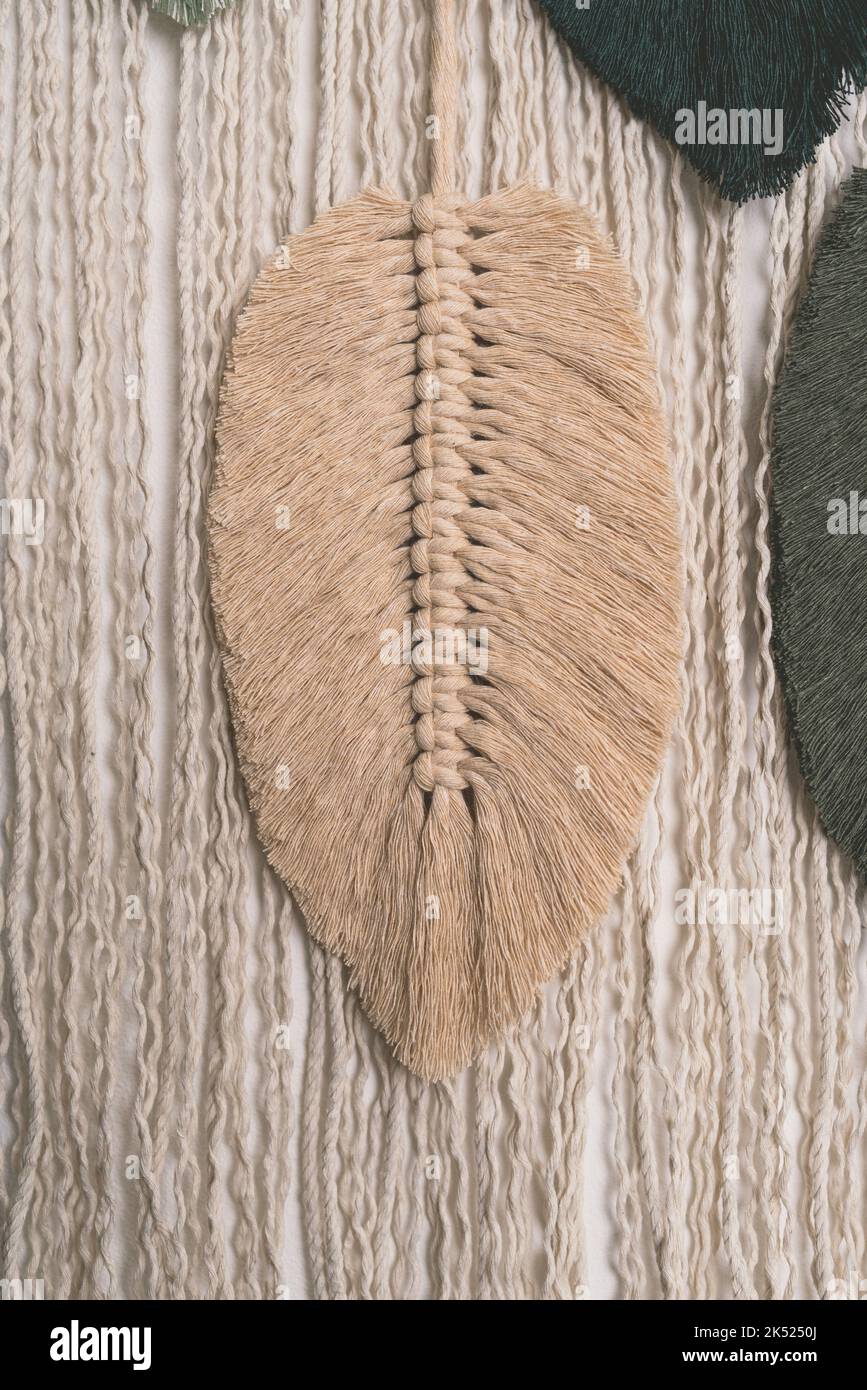 macrame beige feather cotton string on wall feather closeup Stock Photo ...