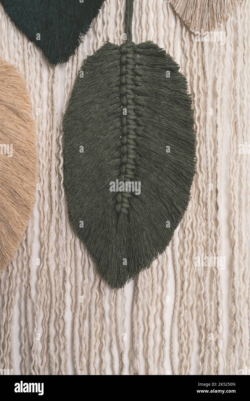 macrame olive green feather cotton string on wall feather closeup Stock ...