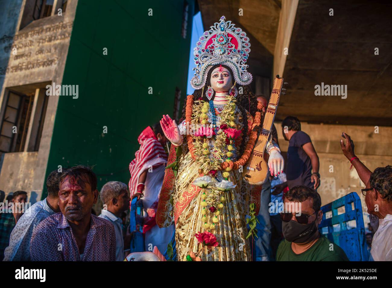 Hindu devotees carry an idol of the goddess Durga during the final day ...