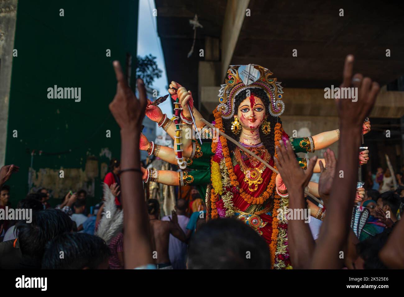 Hindu devotees carry an idol of the goddess Durga during the final day ...