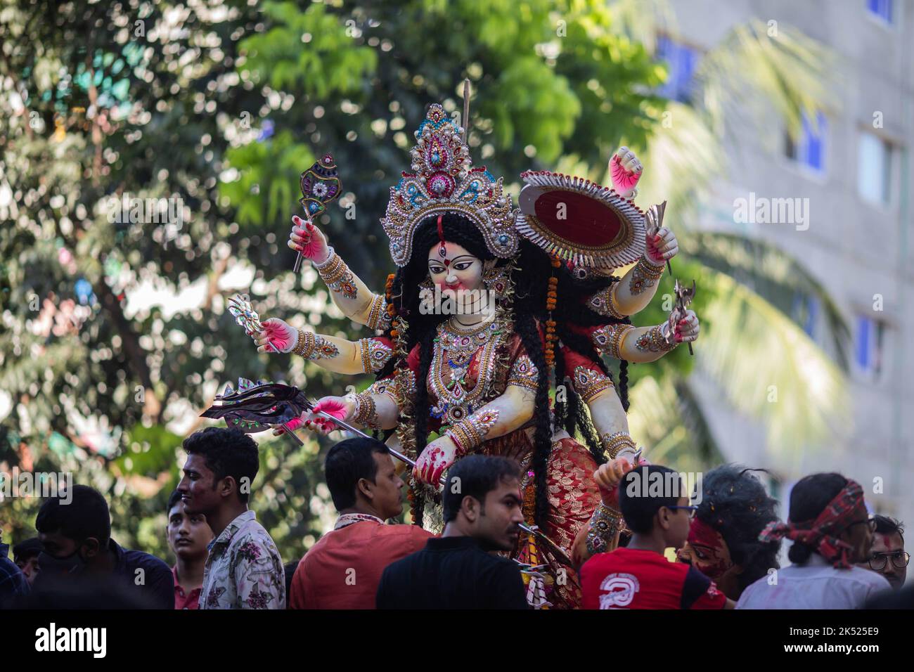 Hindu devotees carry an idol of the goddess Durga during the final day ...