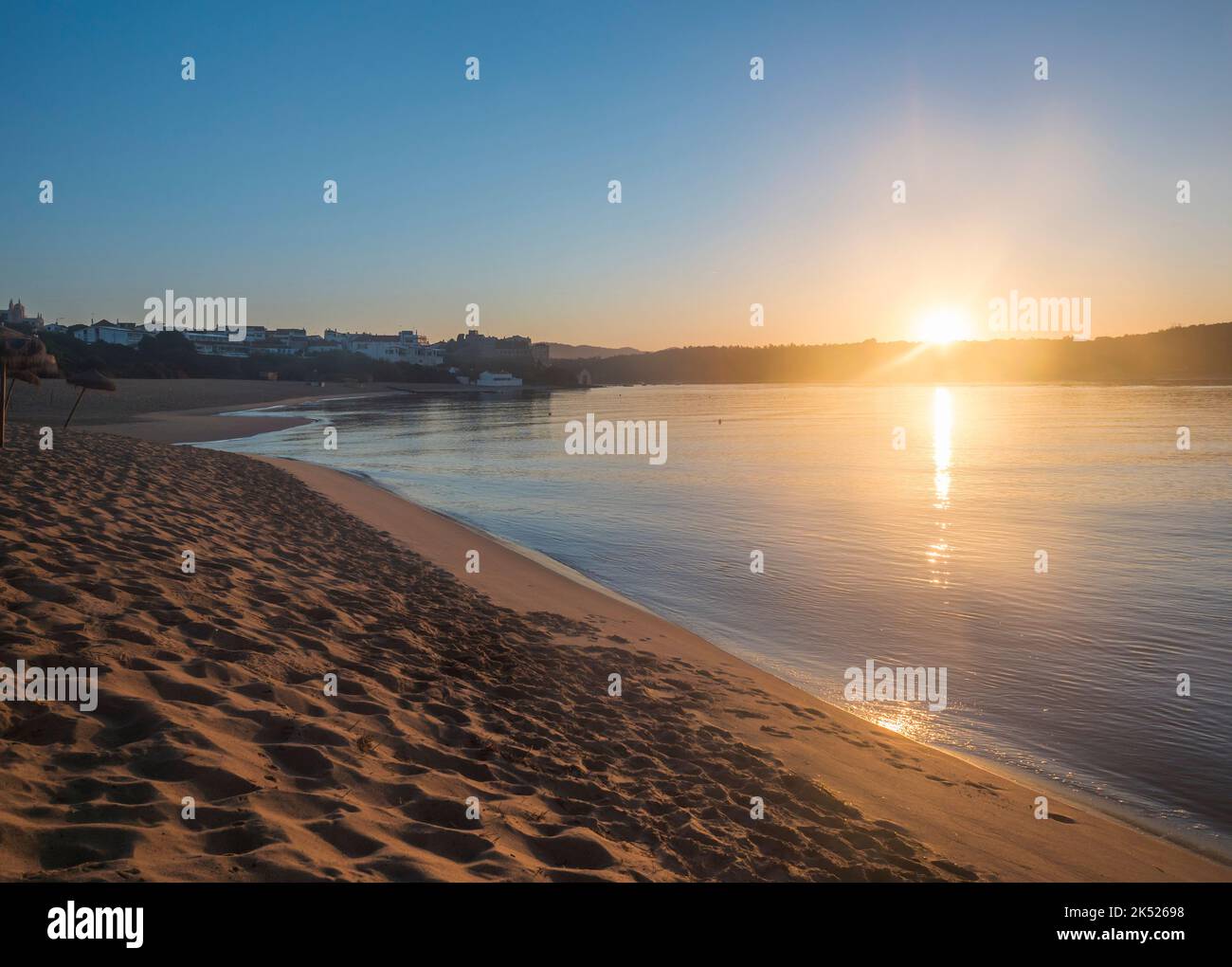 Orange sunrise at empty sand beach Praia da Franquia at Vila Nova de ...