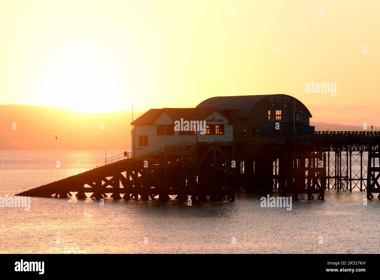 Mumbles lifeboat station at sunrise. The original red and white ...