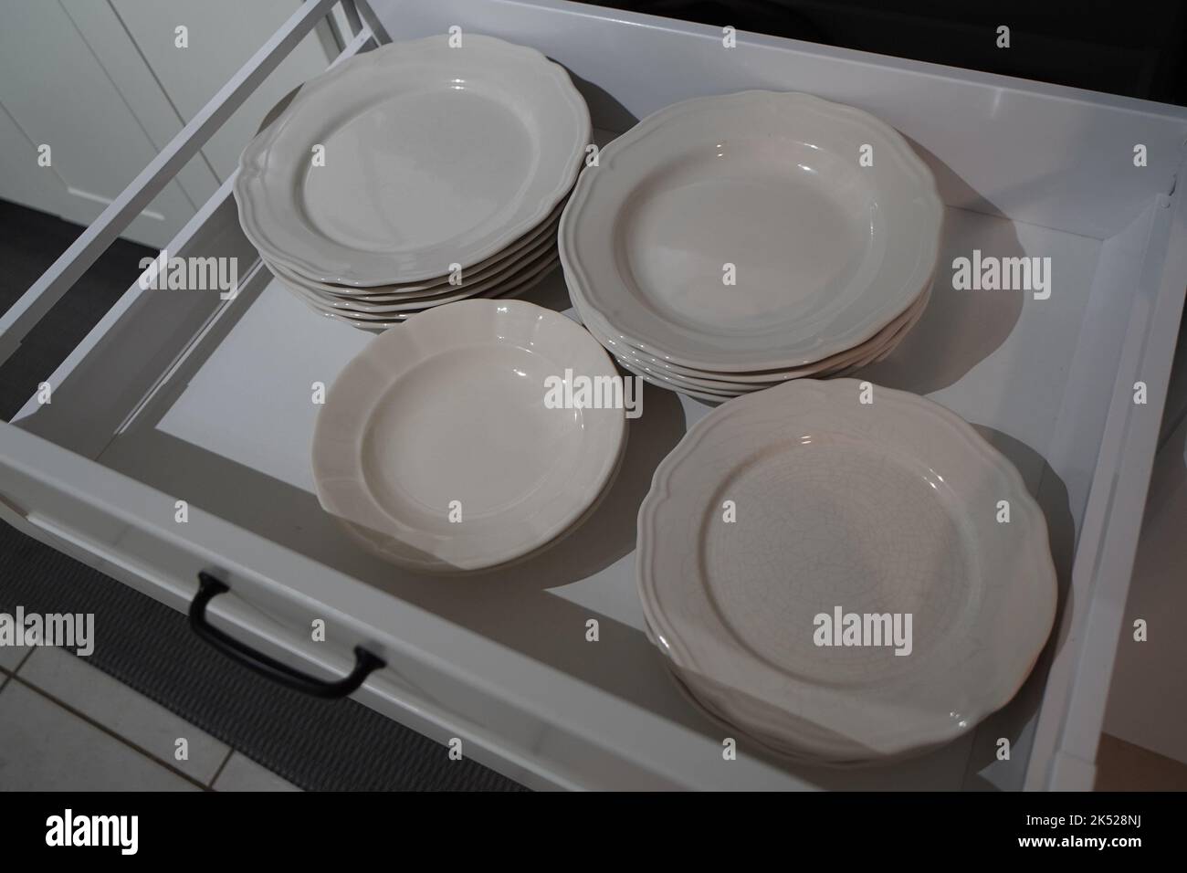 dishes inside kitchen drawer Stock Photo - Alamy