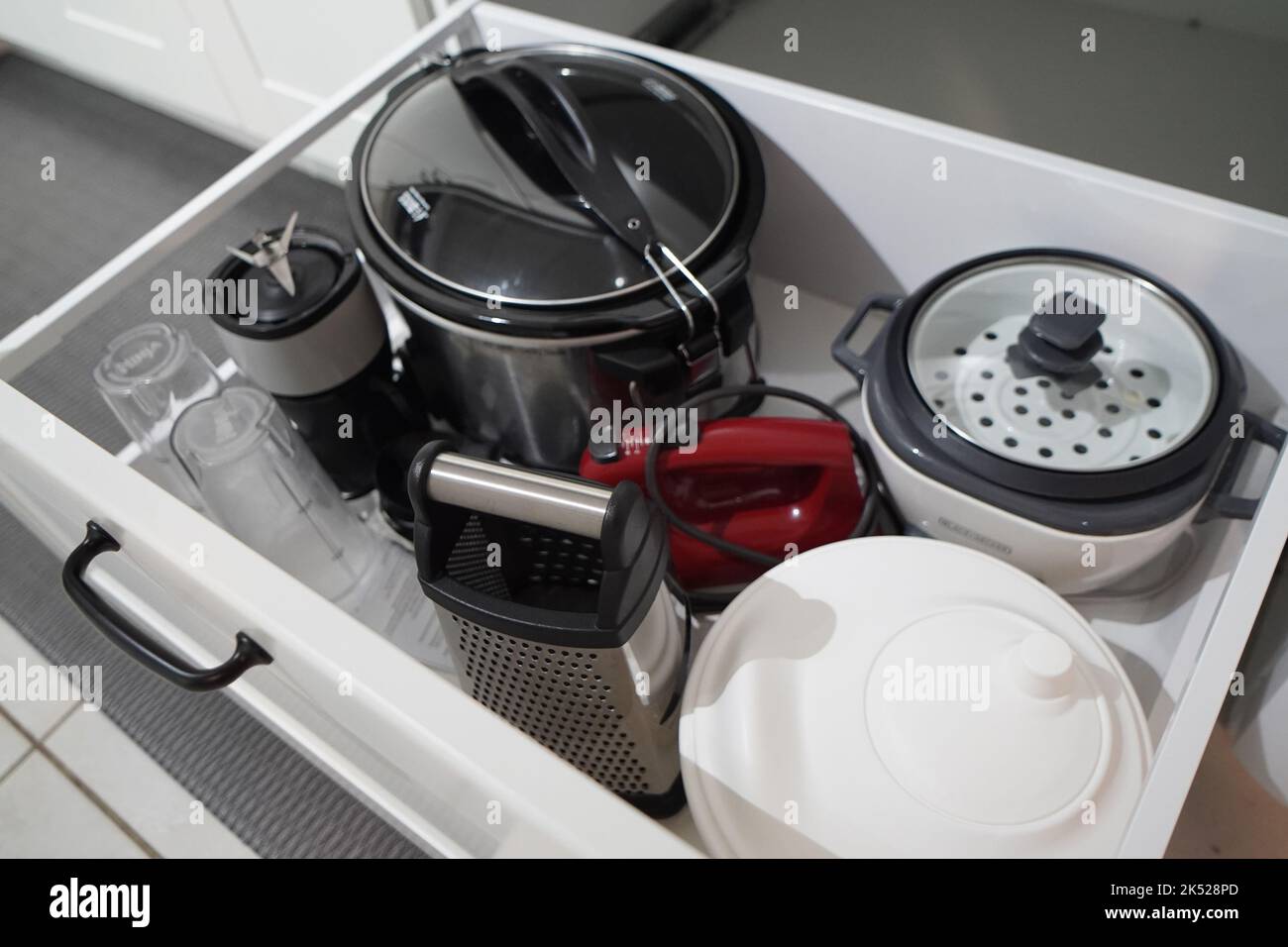 kitchen pots and pans organized and stored inside a white drawer Stock ...