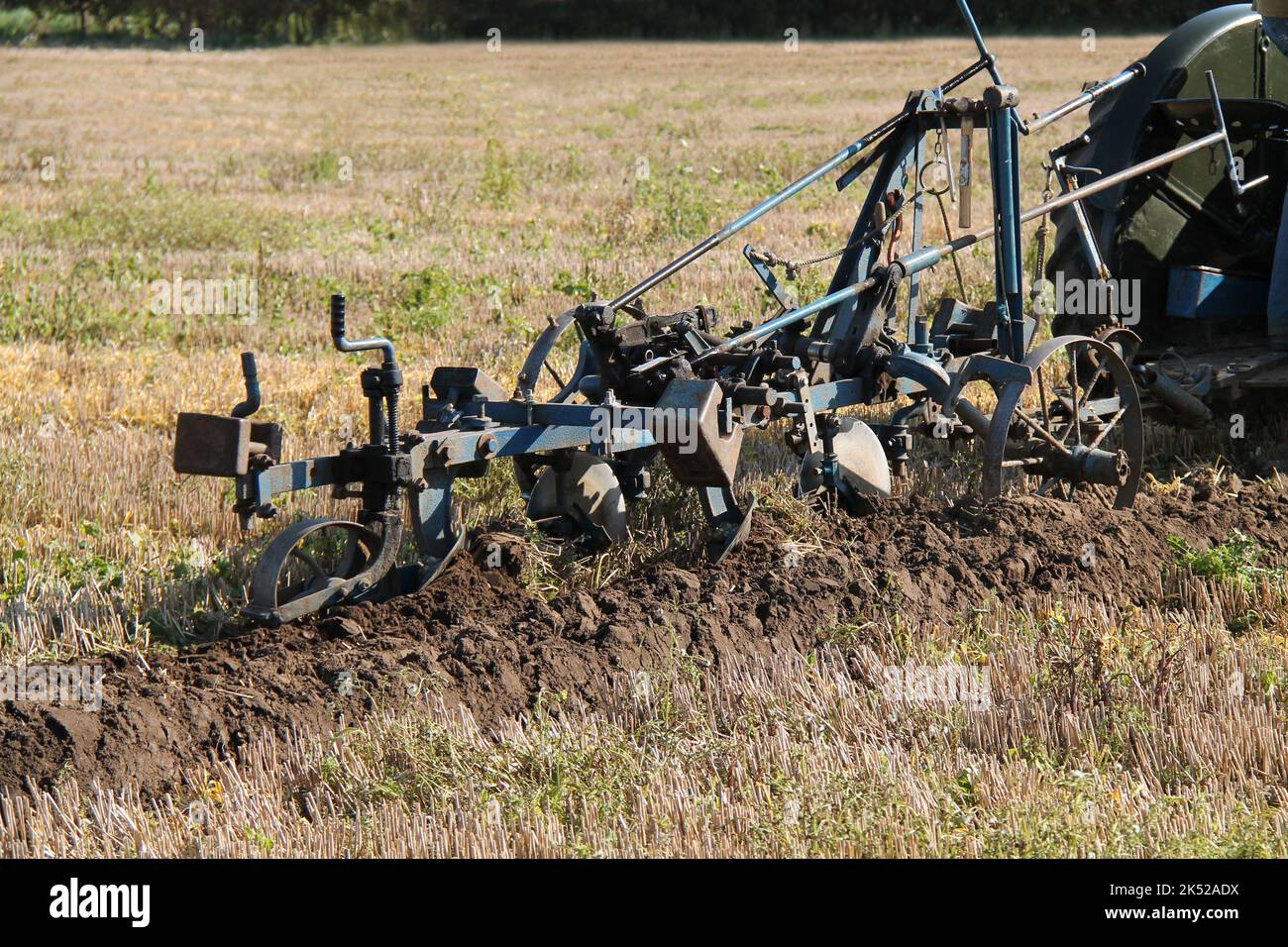 A Vintage Plough Cutting a Furrow in a Field Stock Photo - Alamy
