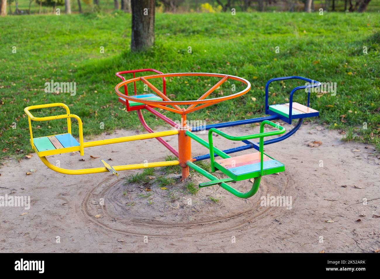 A bright playground surrounded by greenery, many different children's ...