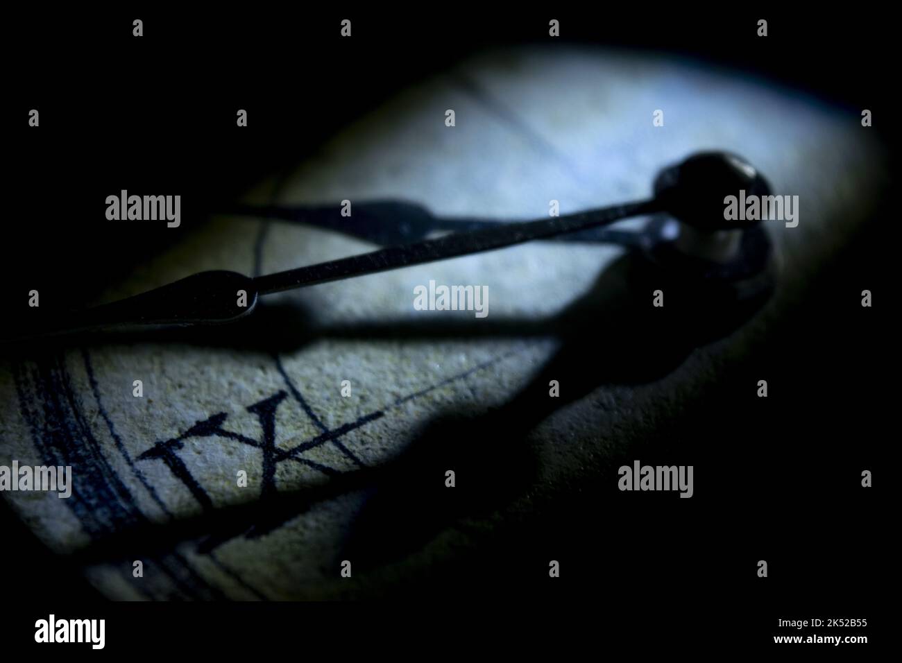 detail of the time in an old clock face with the roman numbers ...